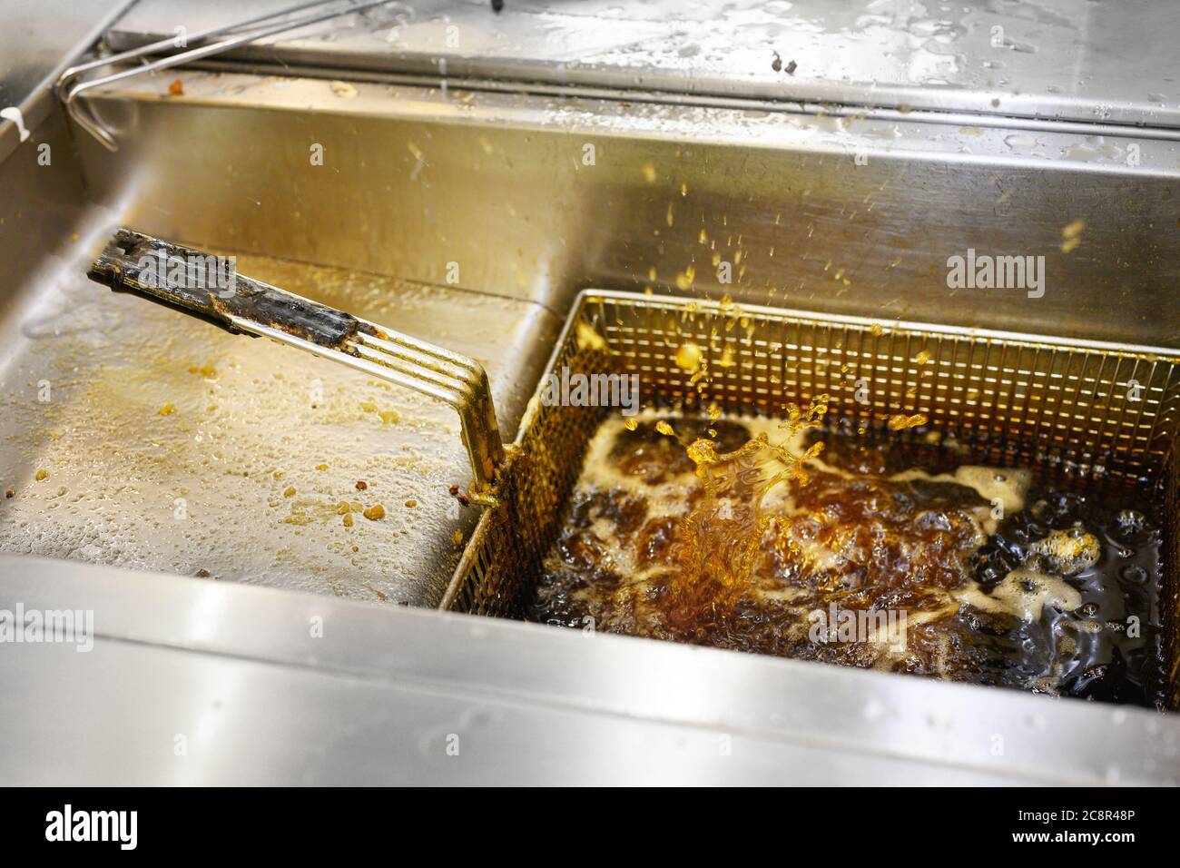 Greasy deep fryer with splashing boiling oil. High quality photo Stock ...