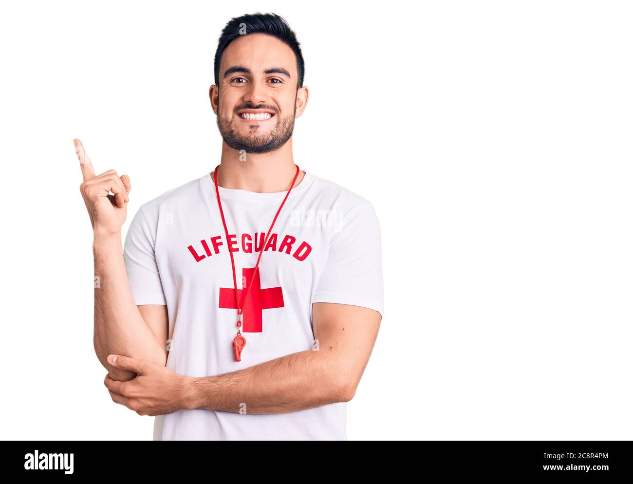Young handsome man wearing lifeguard uniform with a big smile on face ...