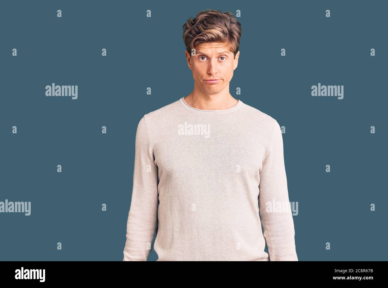 Young handsome man wearing casual clothes depressed and worry for ...