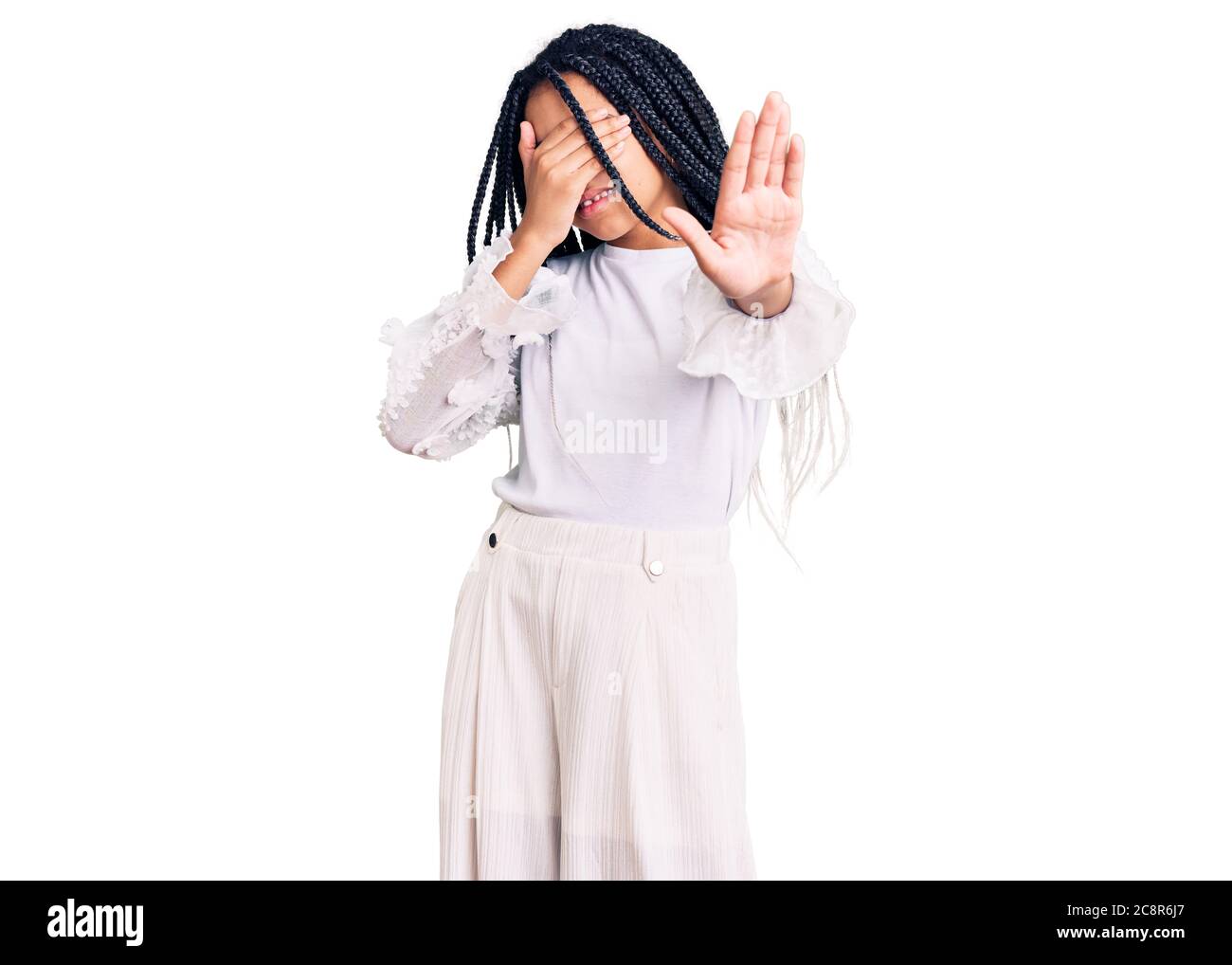 Cute african american girl wearing casual white tshirt covering eyes ...