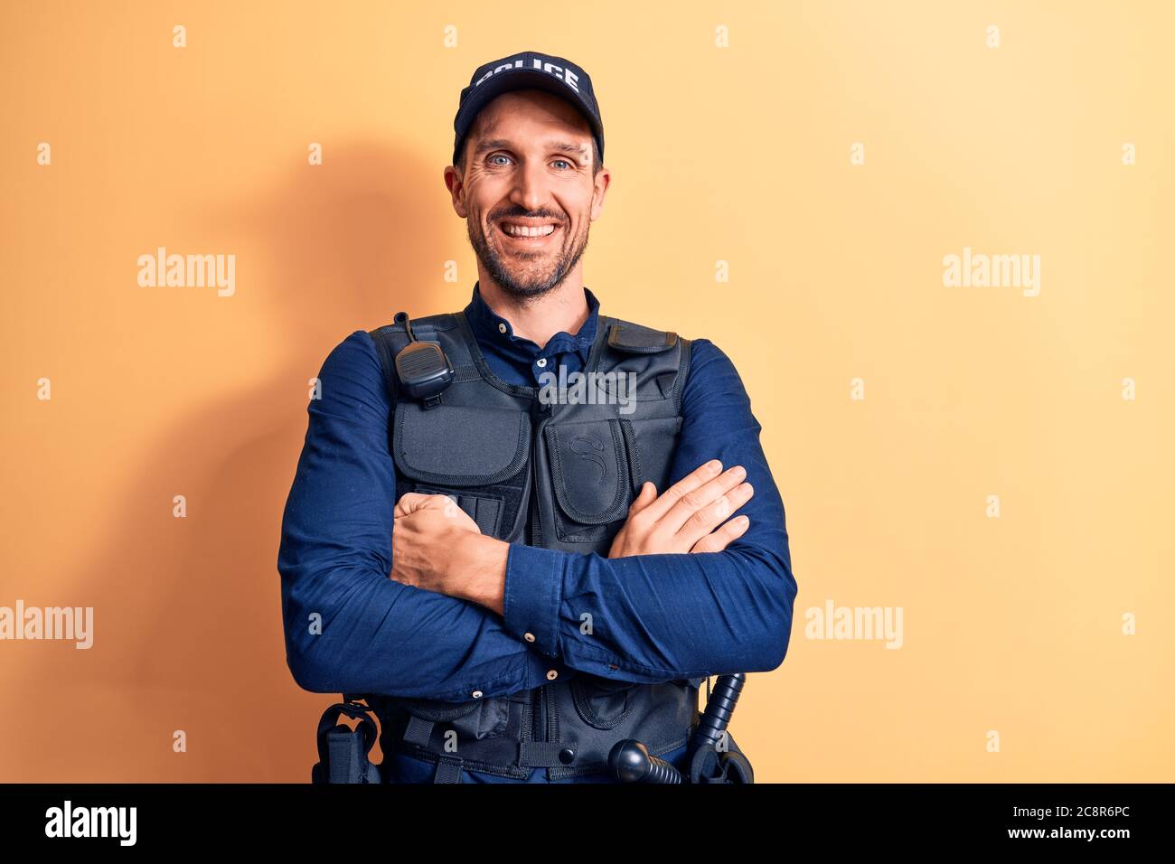 Young handsome policeman wearing police uniform and bulletprof over ...
