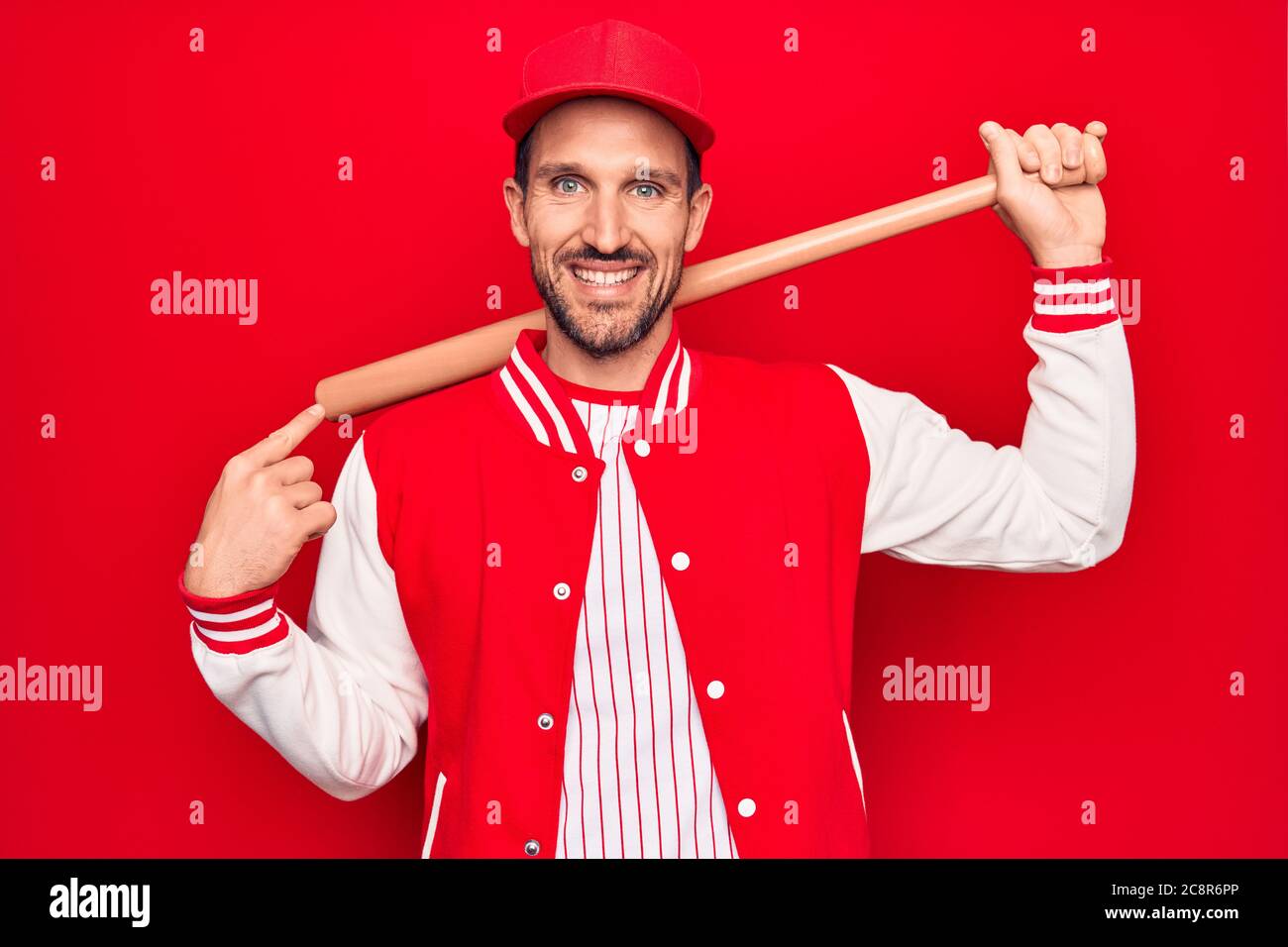 Young handsome player man wearing sportswear playing baseball using bat ...