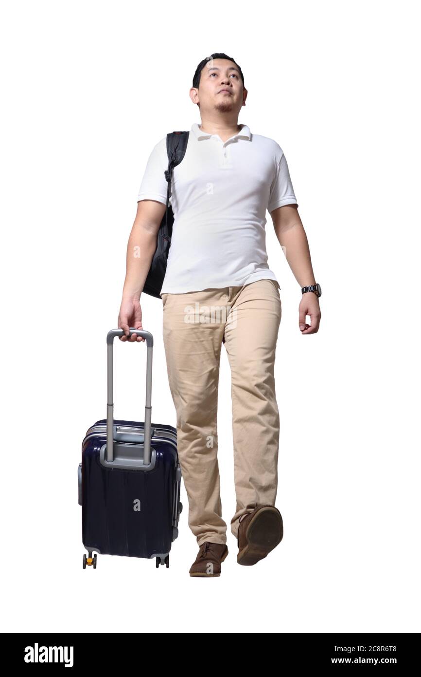 Asian man traveler walking forward drag his suitcase luggage, wearing ...
