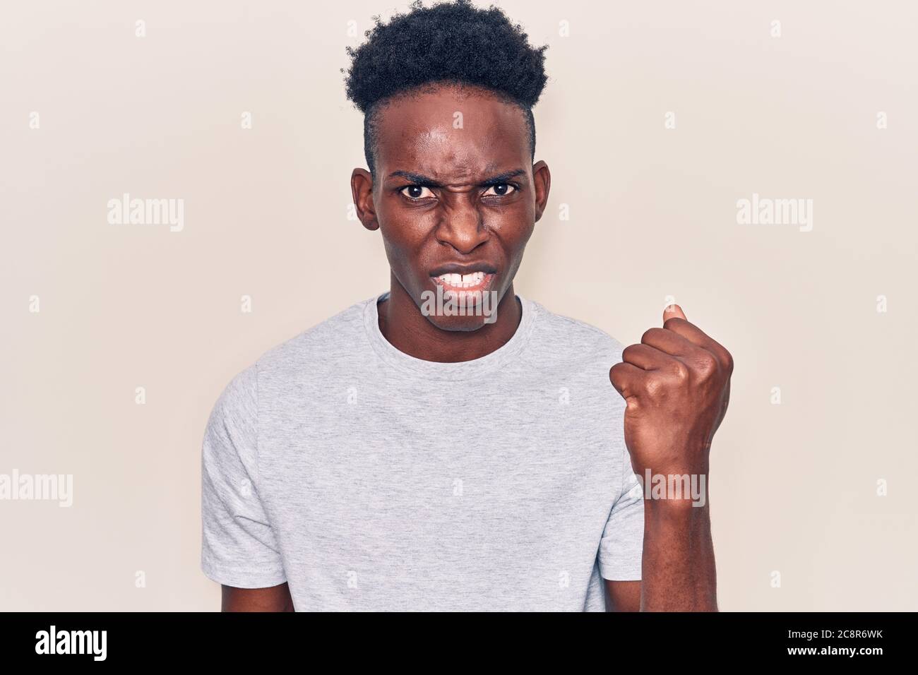 Young african american man wearing casual clothes angry and mad raising ...