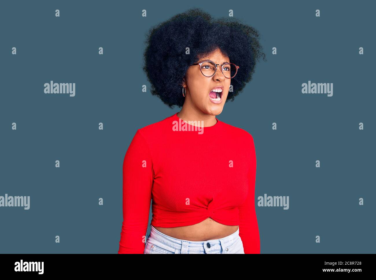 Young african american girl wearing casual clothes and glasses angry ...
