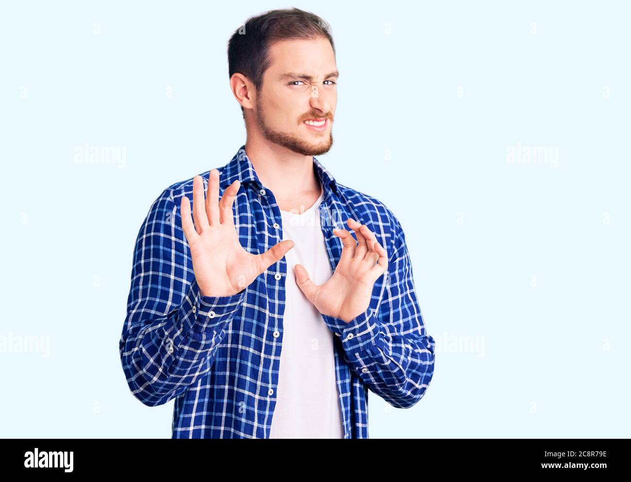 Young handsome caucasian man wearing casual clothes disgusted ...