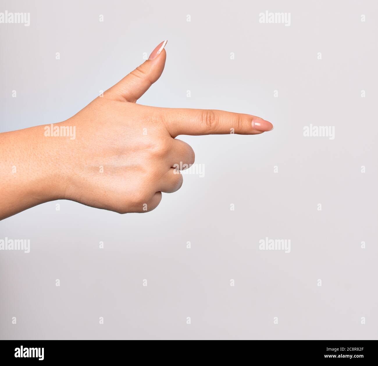 Hand of caucasian young businesswoman doing gun symbol pointing with ...