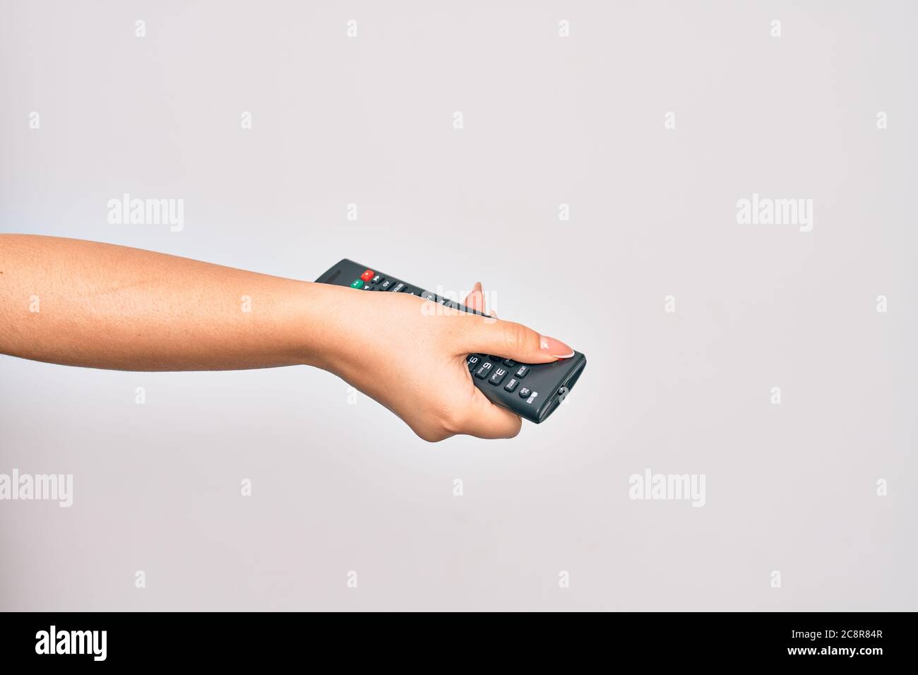 Hand of caucasian young woman changing television channel holding tv ...