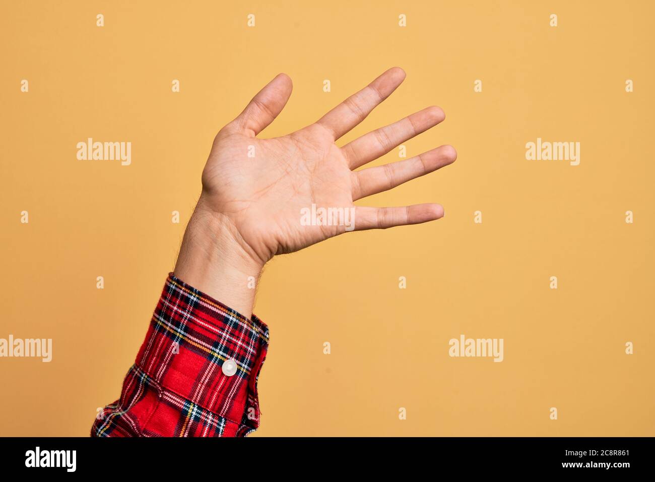 Hand of caucasian young man showing fingers over isolated yellow ...