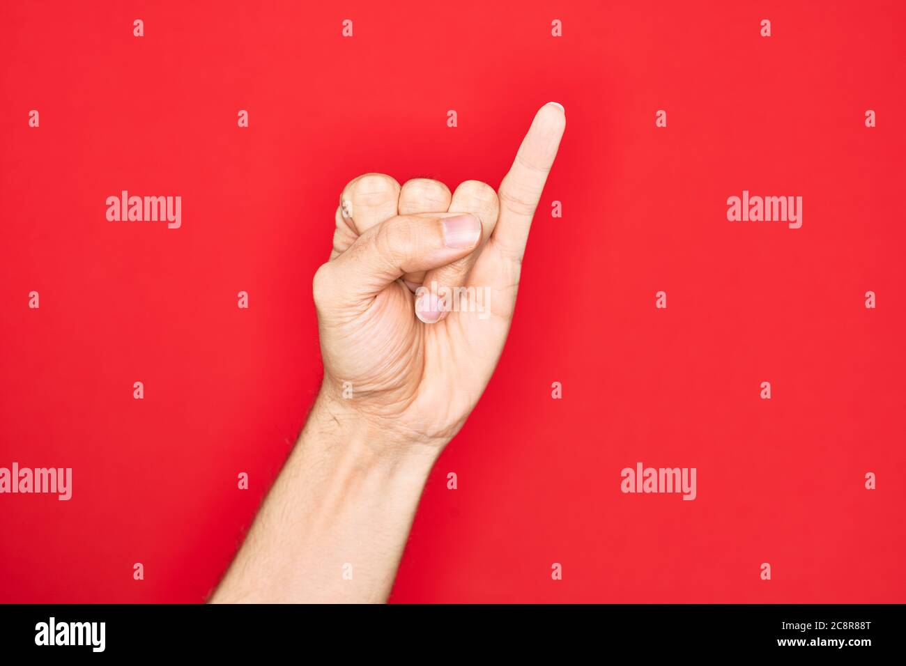 Hand of caucasian young man showing fingers over isolated red ...