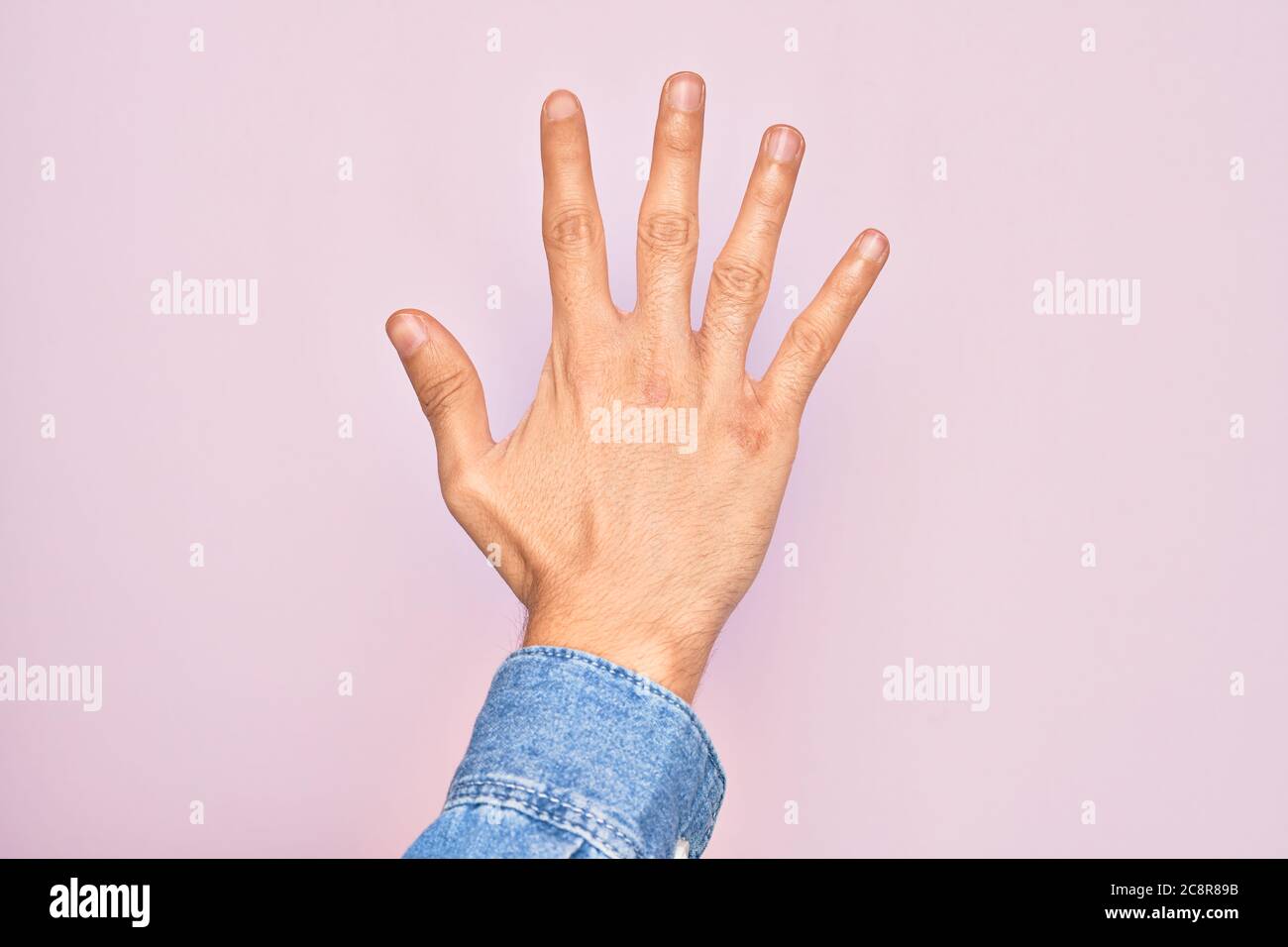 Hand of caucasian young man showing fingers over isolated pink ...