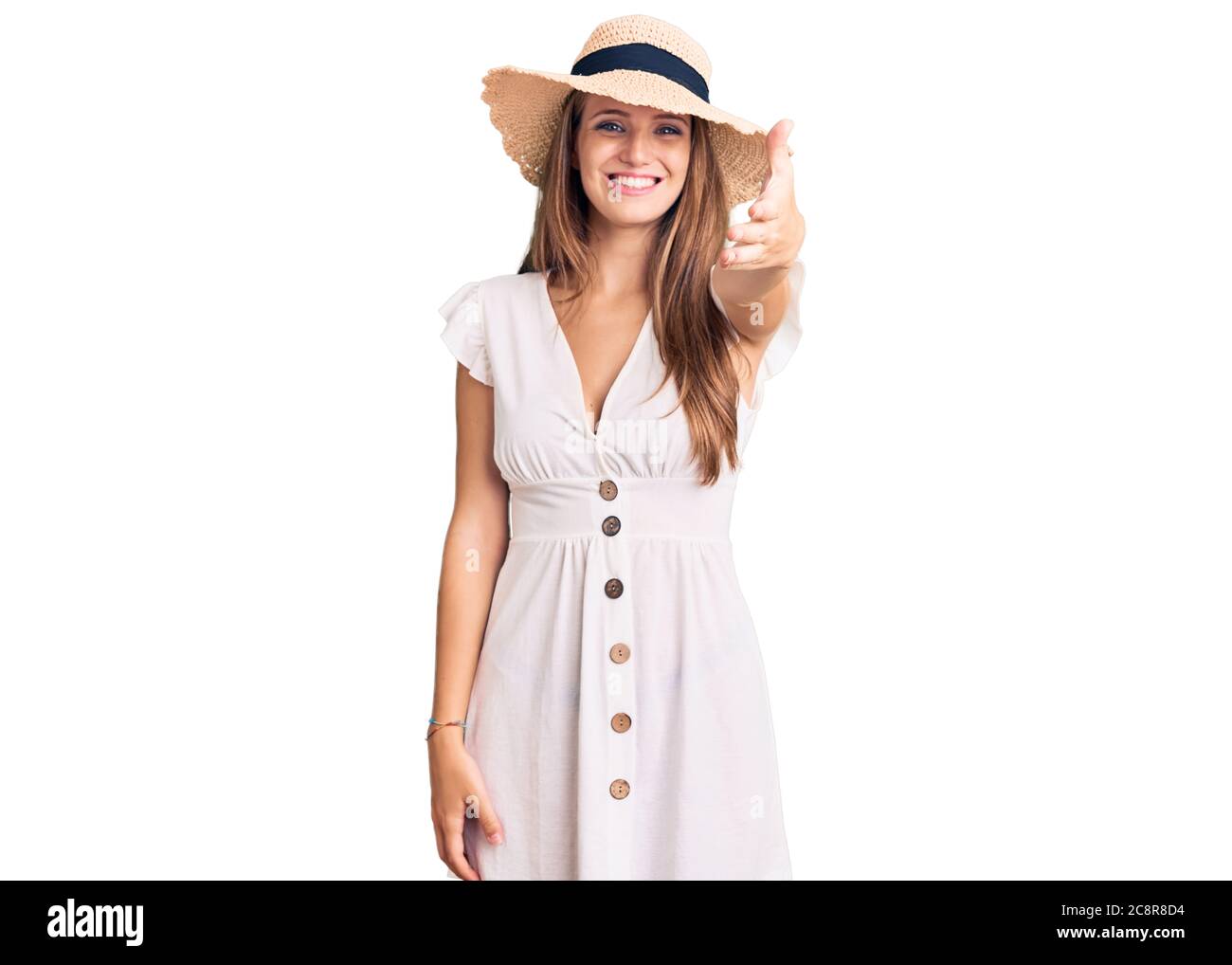 Young beautiful blonde woman wearing summer dress and hat smiling ...