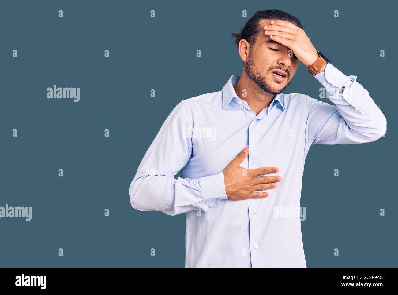 Young handsome man wearing business clothes touching forehead for ...