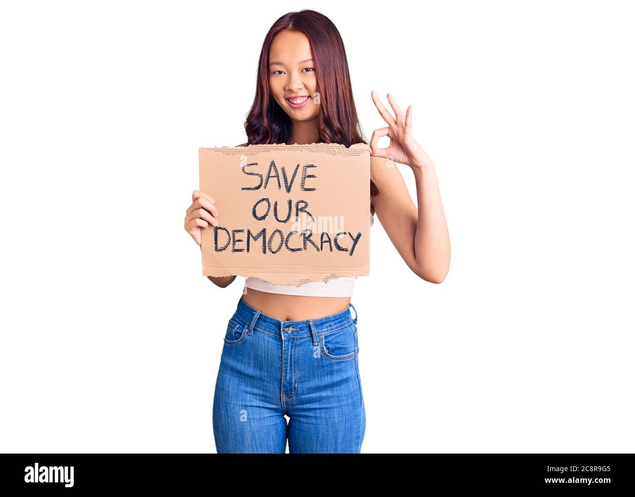 Young beautiful chinese girl holding save our democracy protest banner ...