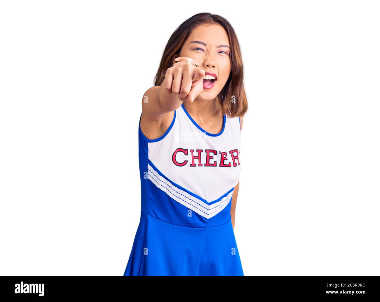 Young beautiful chinese girl wearing cheerleader uniform pointing ...
