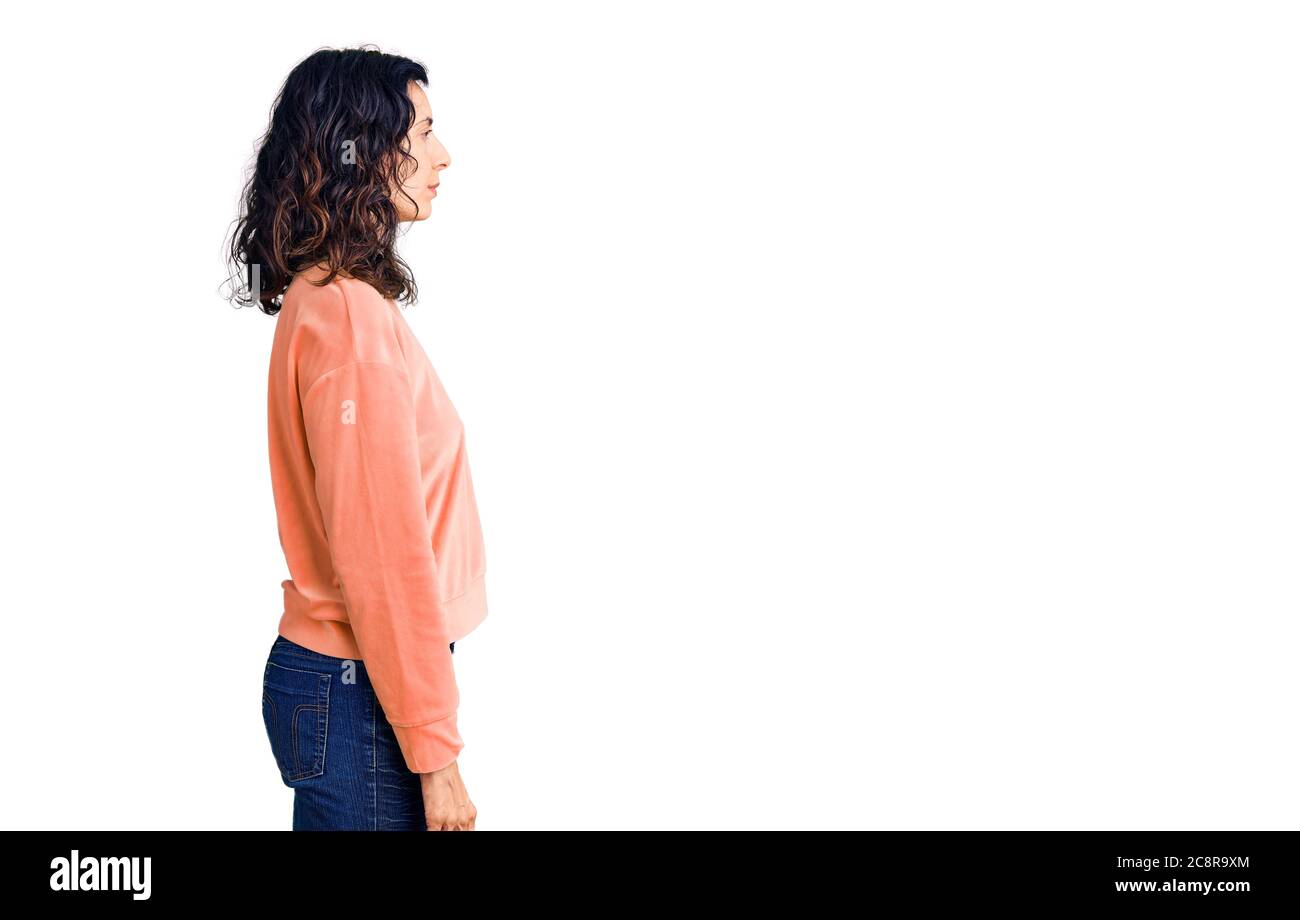 Young beautiful hispanic woman wearing casual clothes looking to side ...