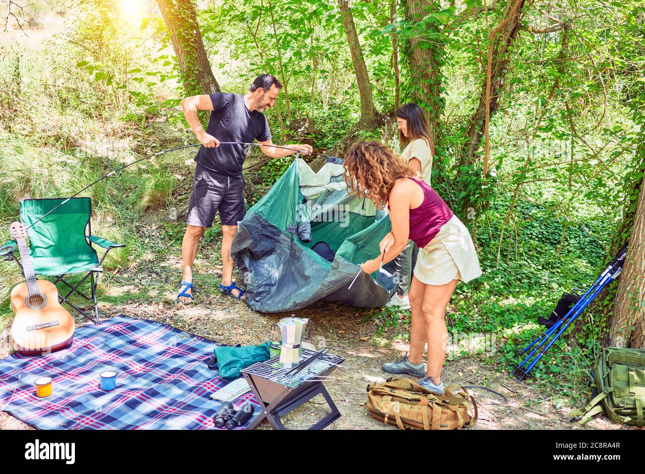 Family of hiker setting up the tent to camping at the forest Stock ...