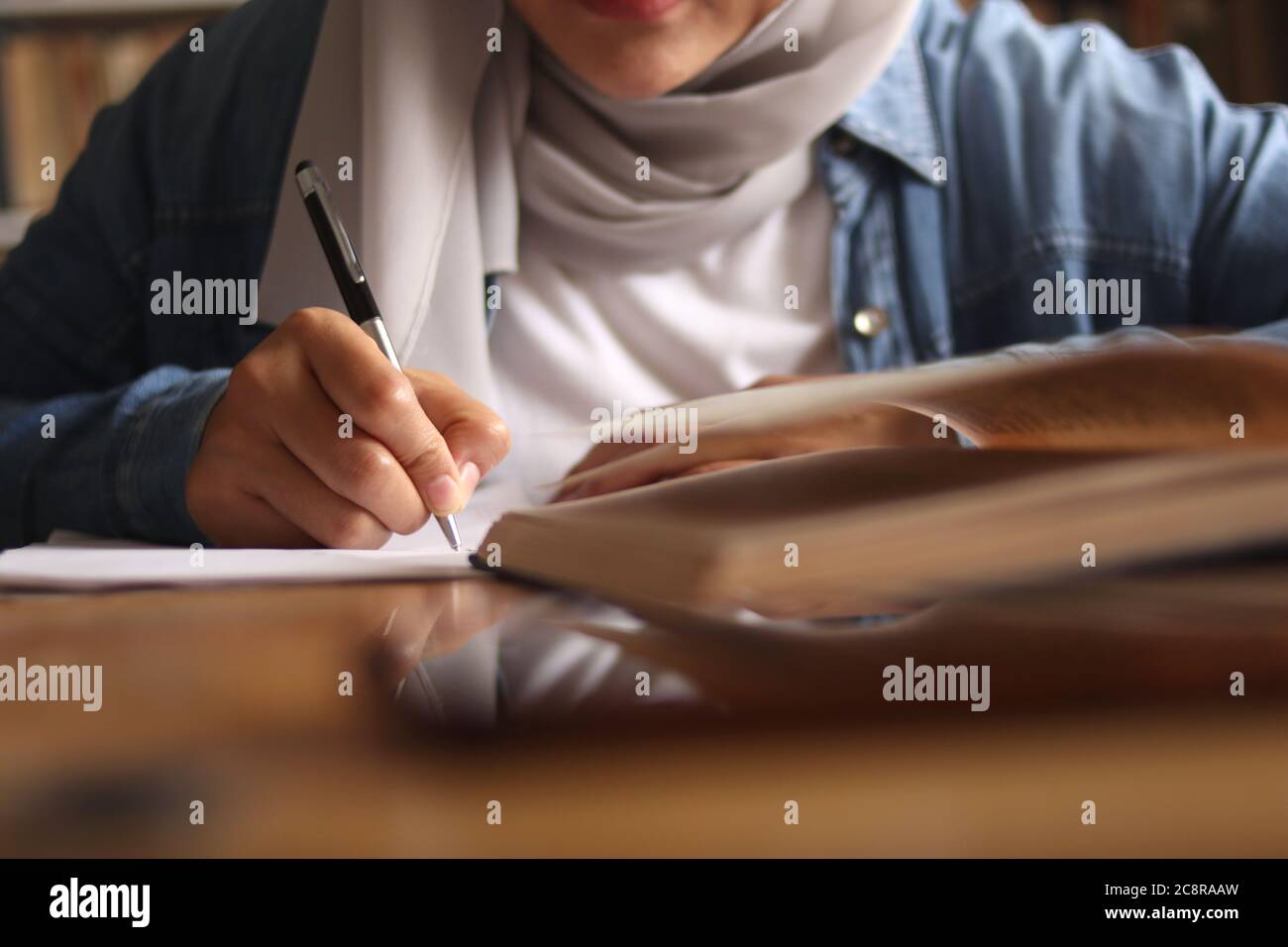 Asian muslim woman studying learning in library, exam preparation ...