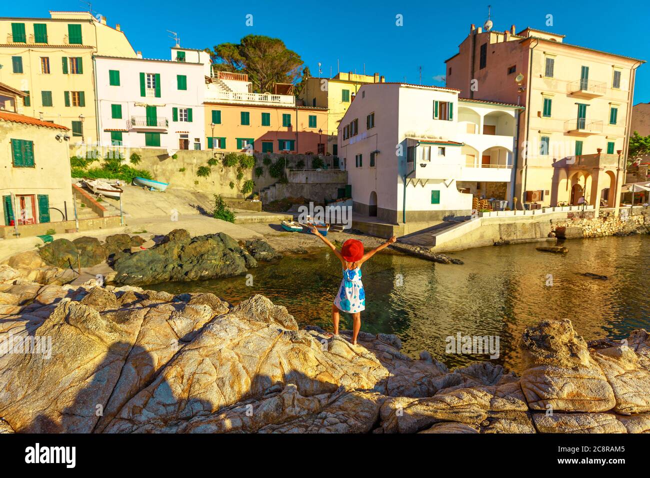 Happy tourist woman enjoying over cliffs at Marciana Marina in Borgo al ...