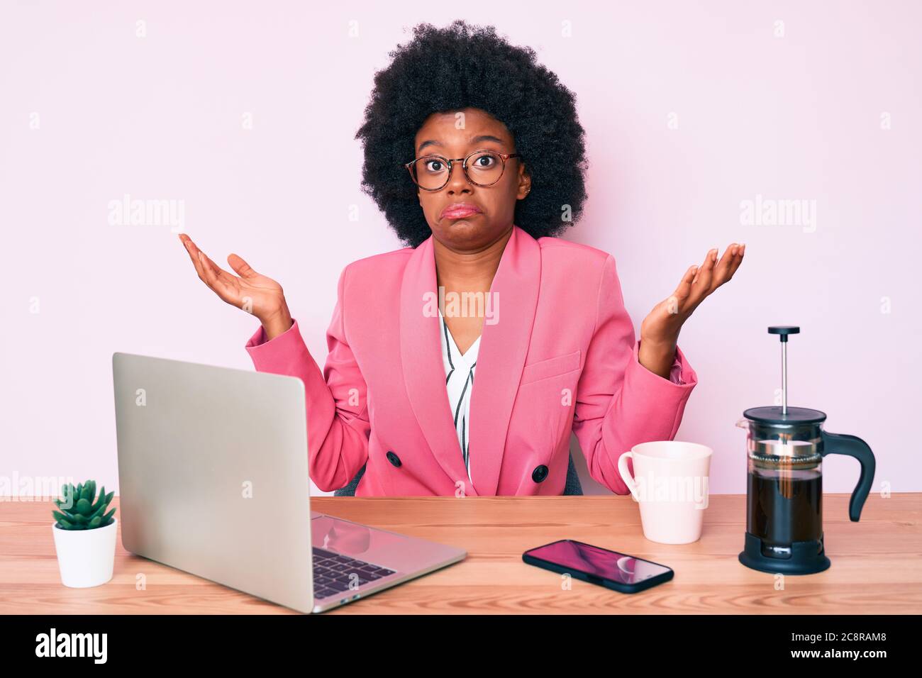 Young african american woman working at desk using computer laptop ...