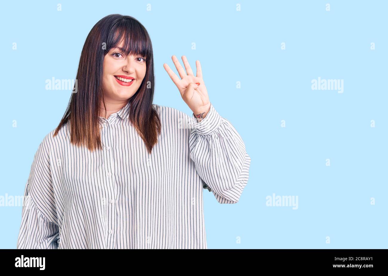 Young plus size woman wearing casual clothes showing and pointing up ...