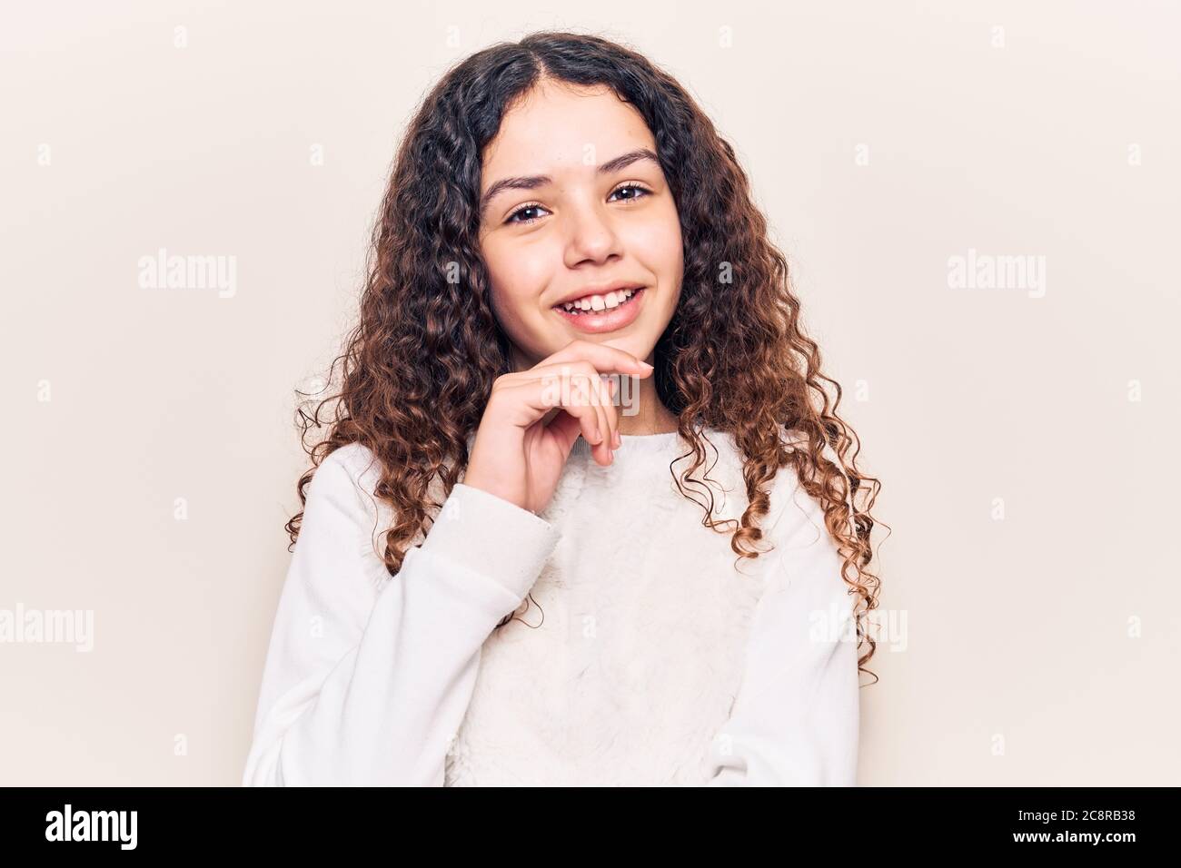 Beautiful kid girl with curly hair wearing casual clothes smiling ...
