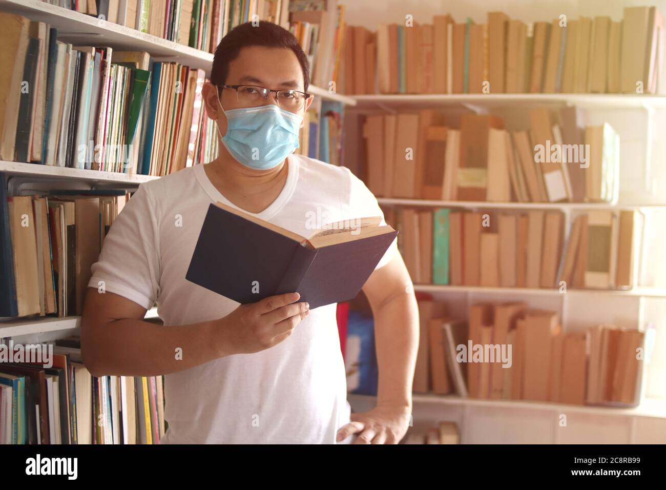 Man learning studying reading book in library during coronavirus ...