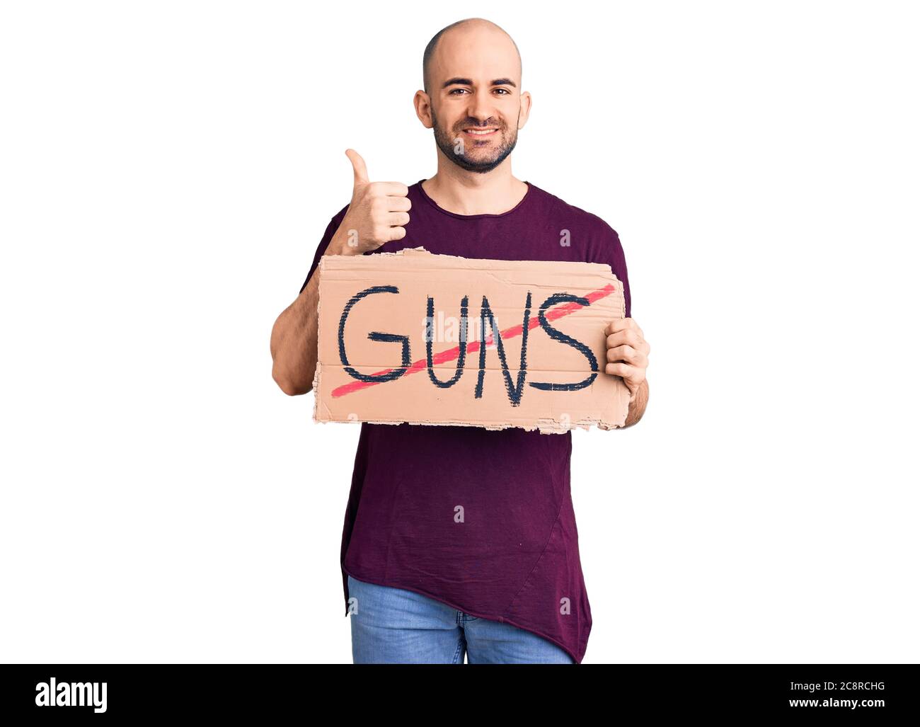 Young handsome man holding prohibited guns banner smiling happy and ...