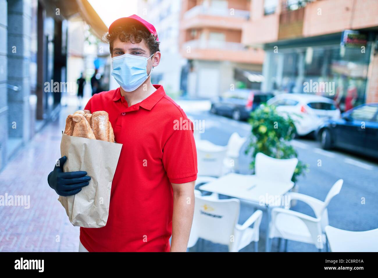 Young caucasian delivery man wearing coronavirus protection medical ...