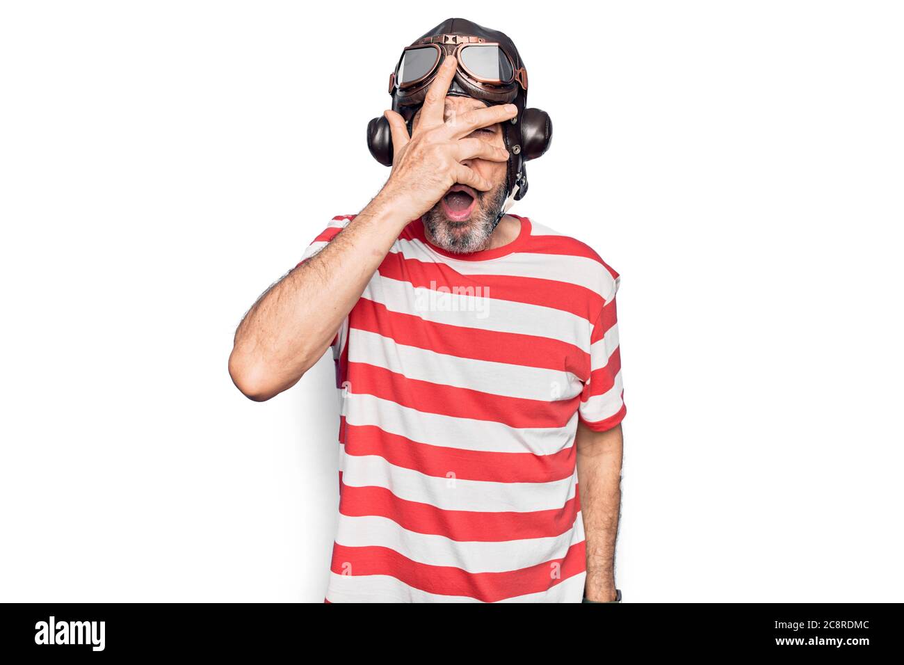 Middle age aviator man wearing vintage helmet and glasses over isolated ...