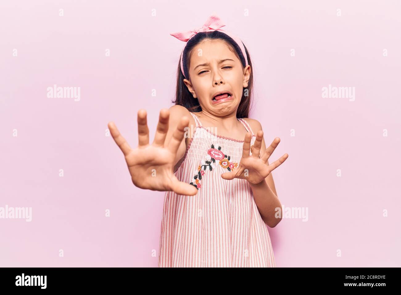 Beautiful child girl wearing casual clothes afraid and terrified with ...