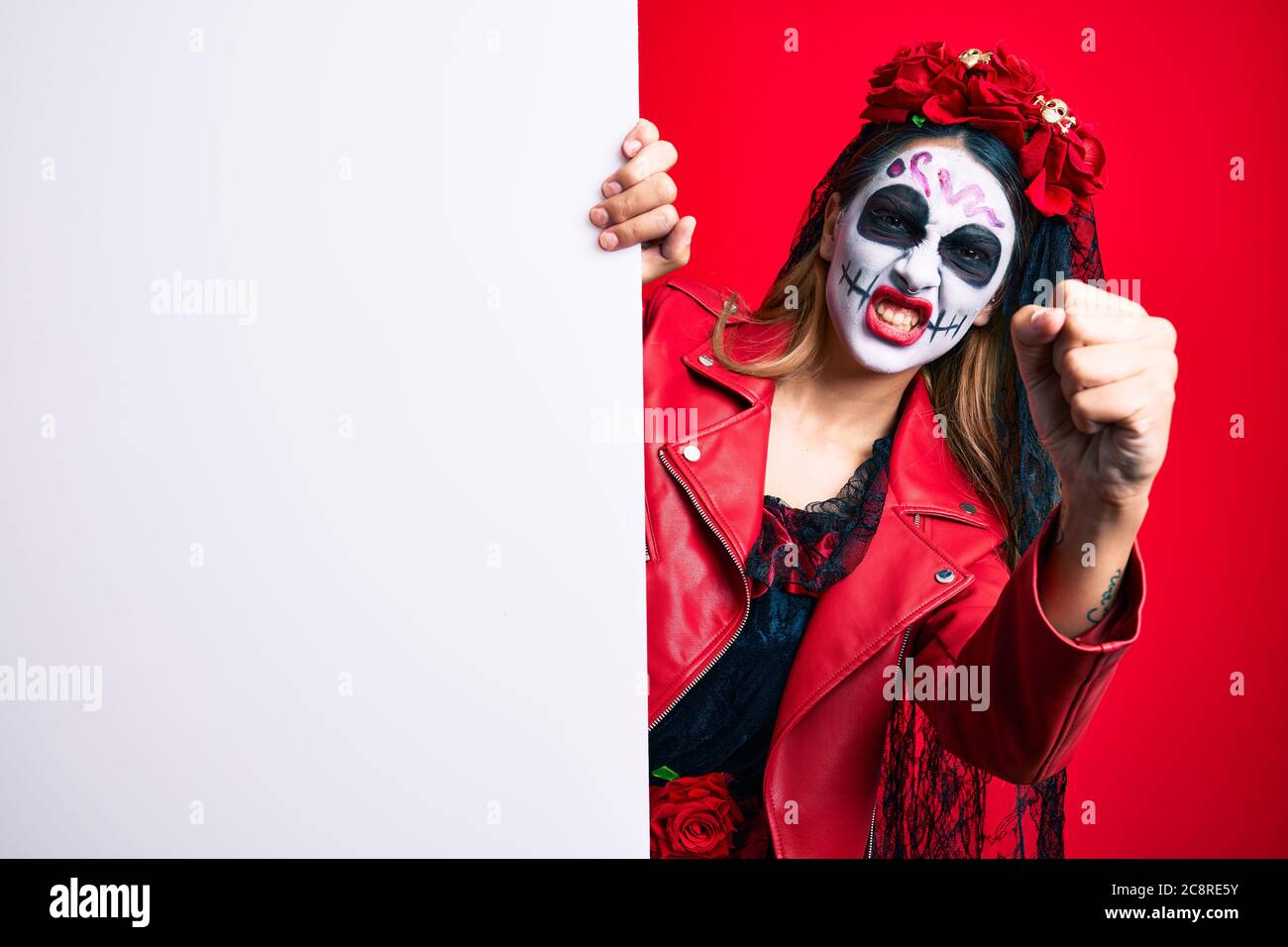 Woman wearing day of the dead costume holding blank empty banner ...