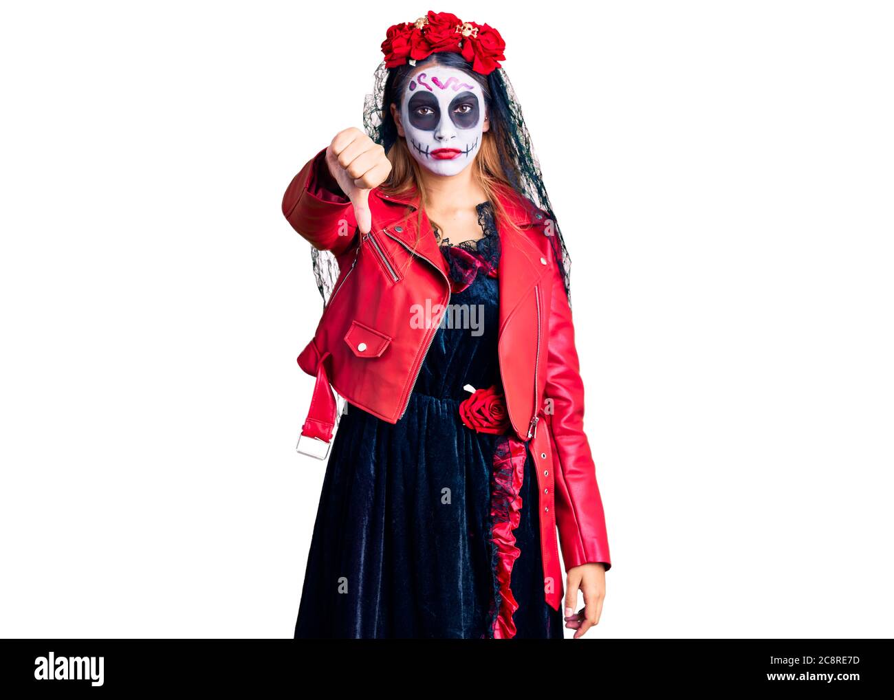Woman wearing day of the dead costume over background looking unhappy ...