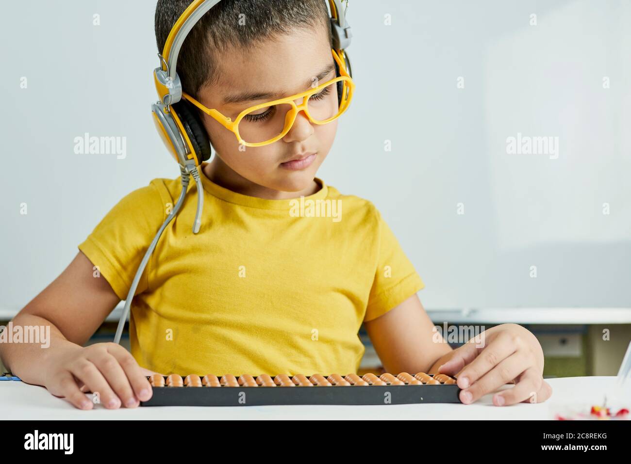 Schoolboy with abacus. Young kid training mental arithmetic - complex ...
