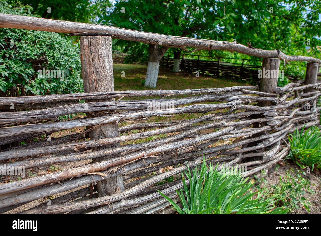 Rustic yard with fence in traditional style . Wicker fence Stock Photo ...