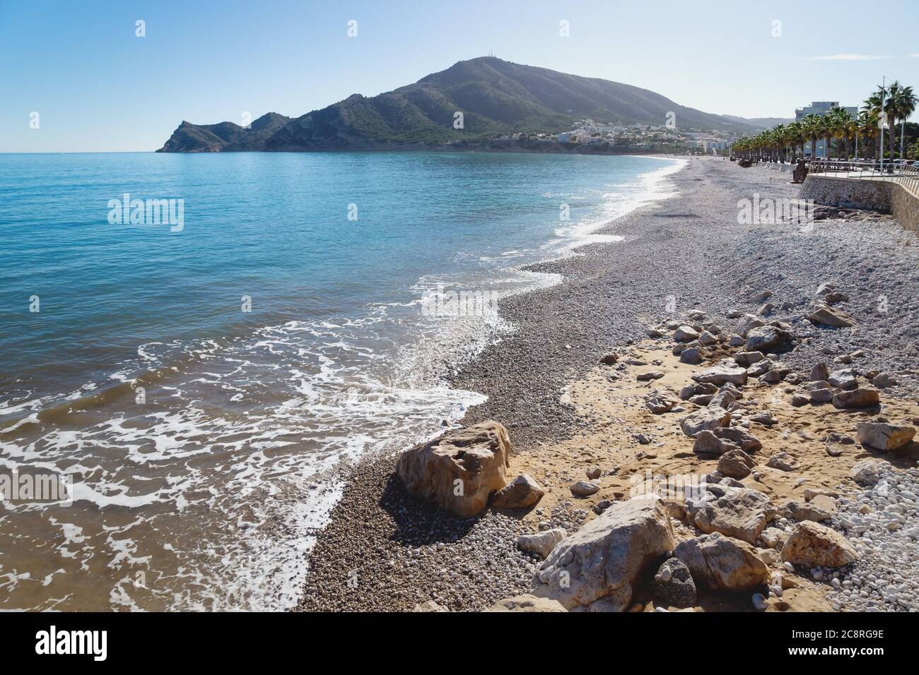 Beach of Albir with turquoise water and view on the promenade aligned ...