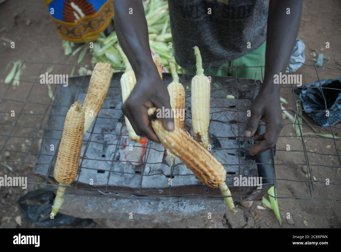 A women selling cooked corn on a grill, Lilongwe, Malawi, Africa Stock ...