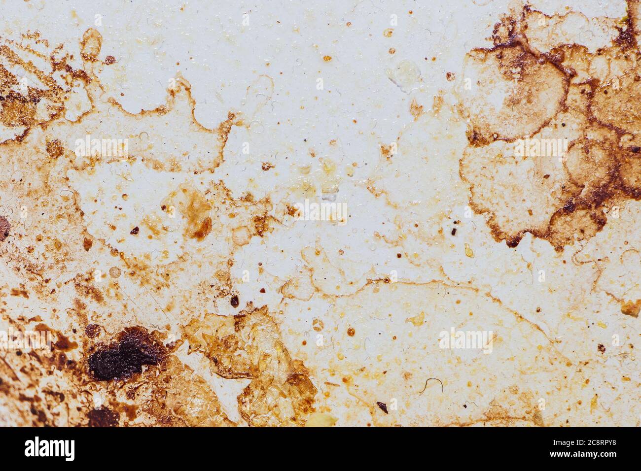 Texture of dirty stains and grease on white stove. Spots of fat on a ...