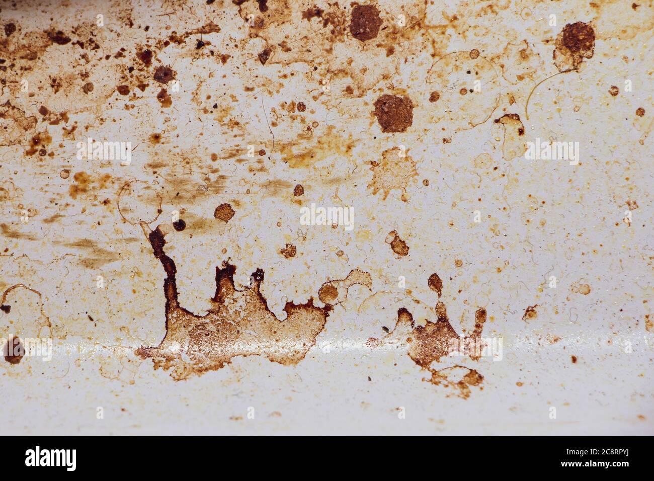 Texture of dirty stains and grease on white stove. Spots of fat on a ...