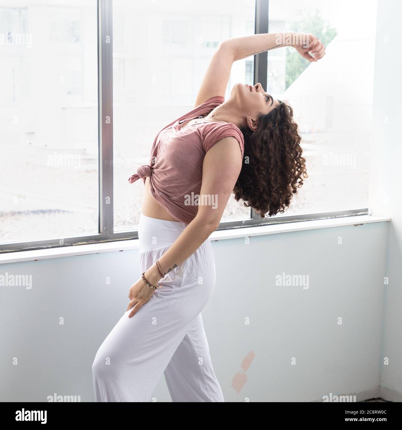 Fitness coach demonstrating stretches in studio Stock Photo - Alamy