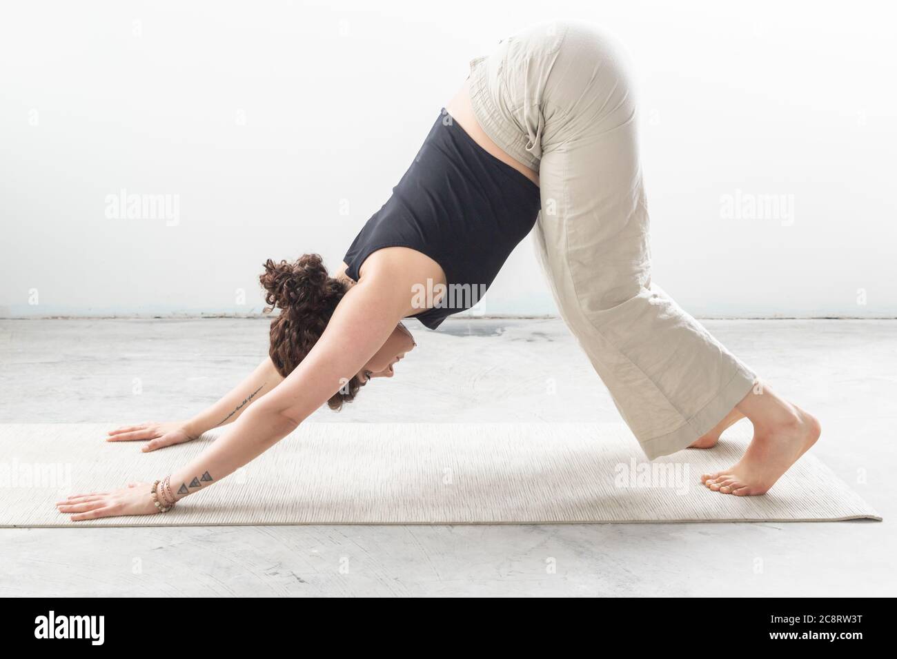 Fitness coach demonstrating stretches in studio Stock Photo - Alamy