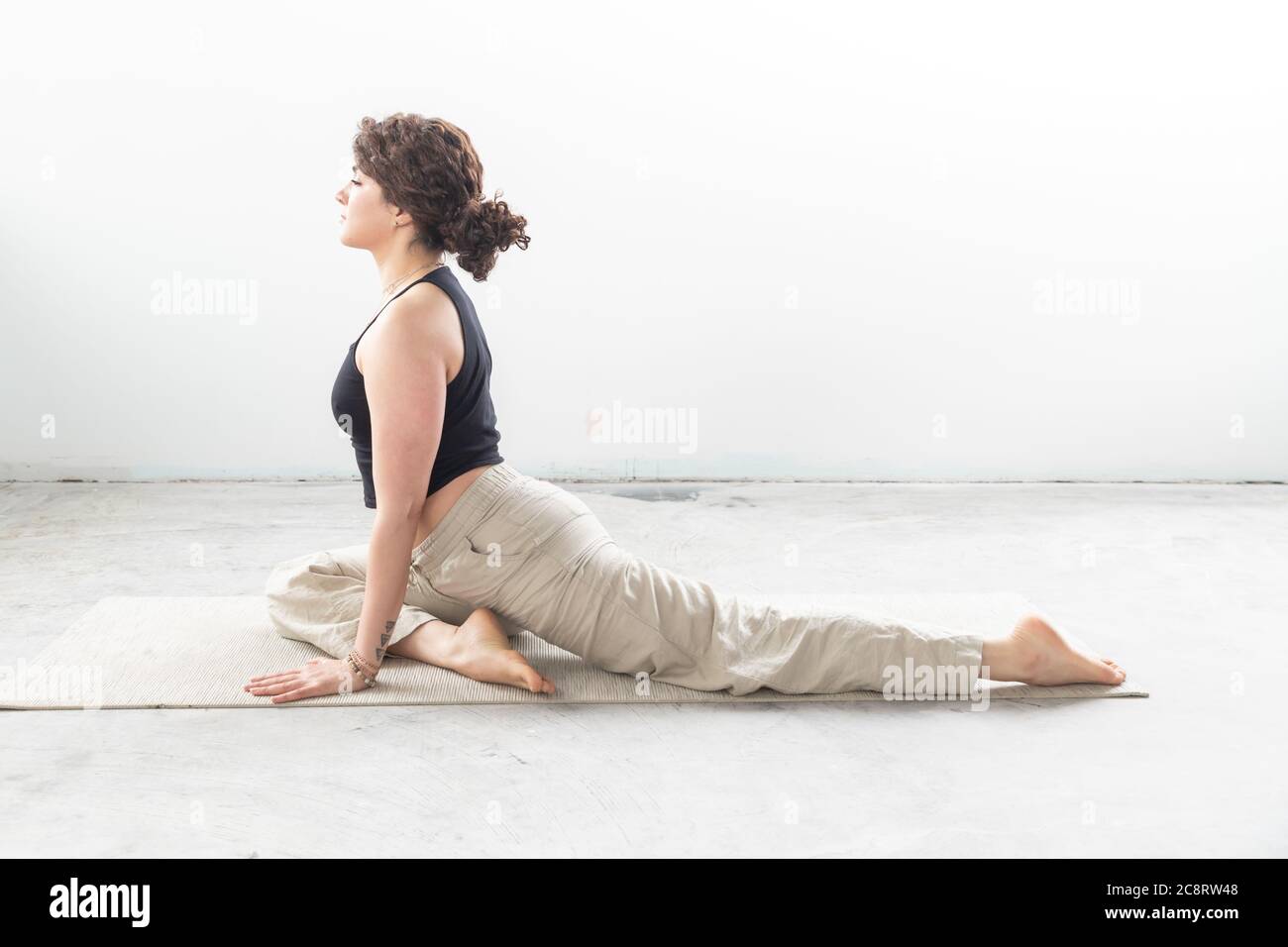 Fitness coach demonstrating stretches in studio Stock Photo - Alamy