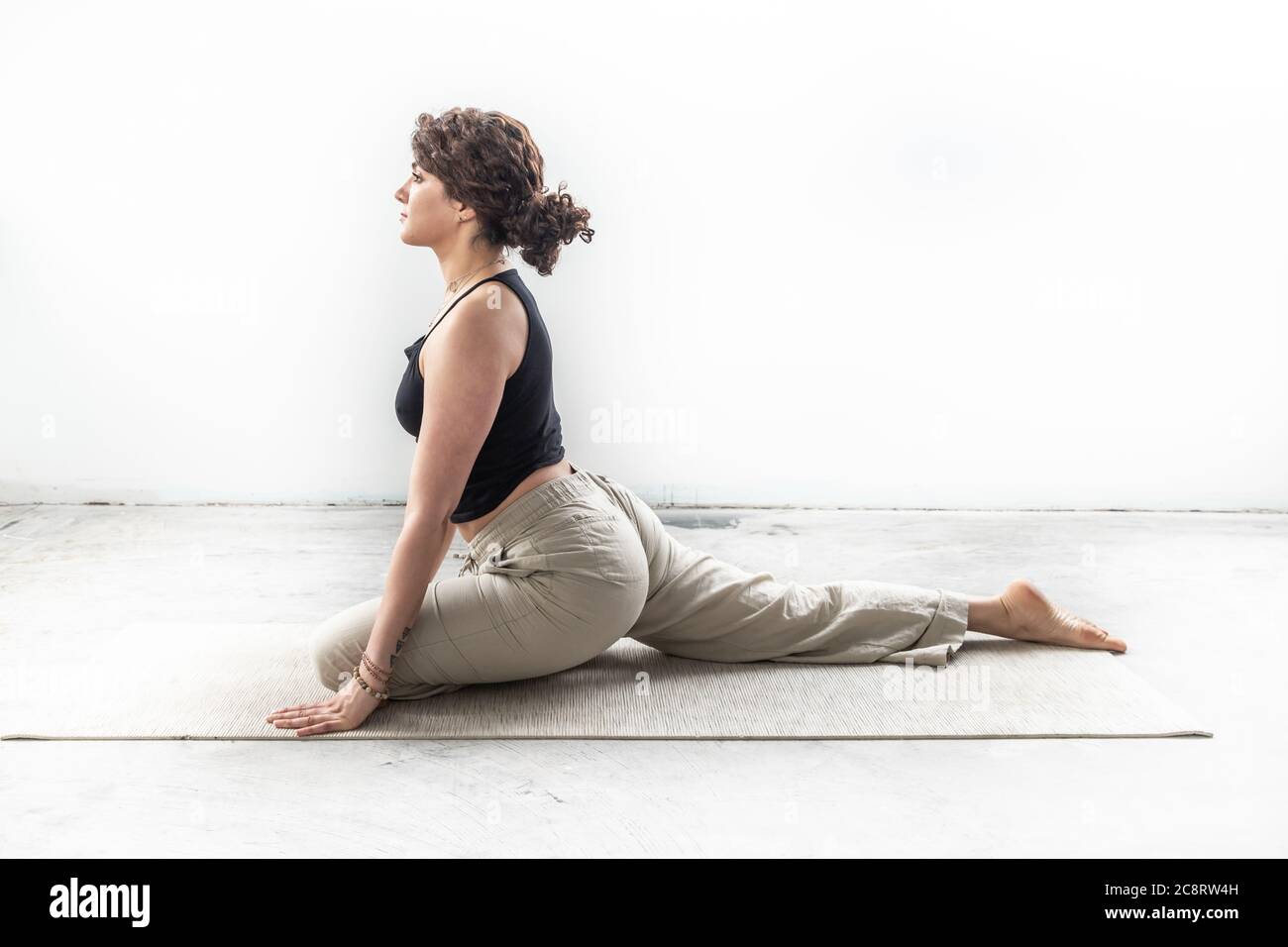 Fitness coach demonstrating stretches in studio Stock Photo - Alamy