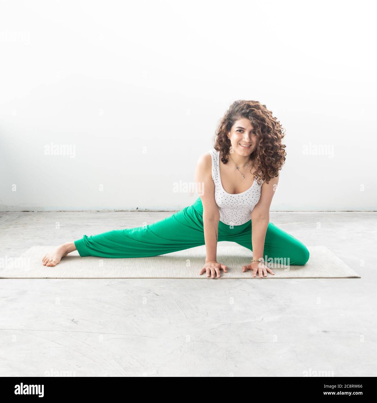 Fitness coach demonstrating stretches in studio Stock Photo - Alamy