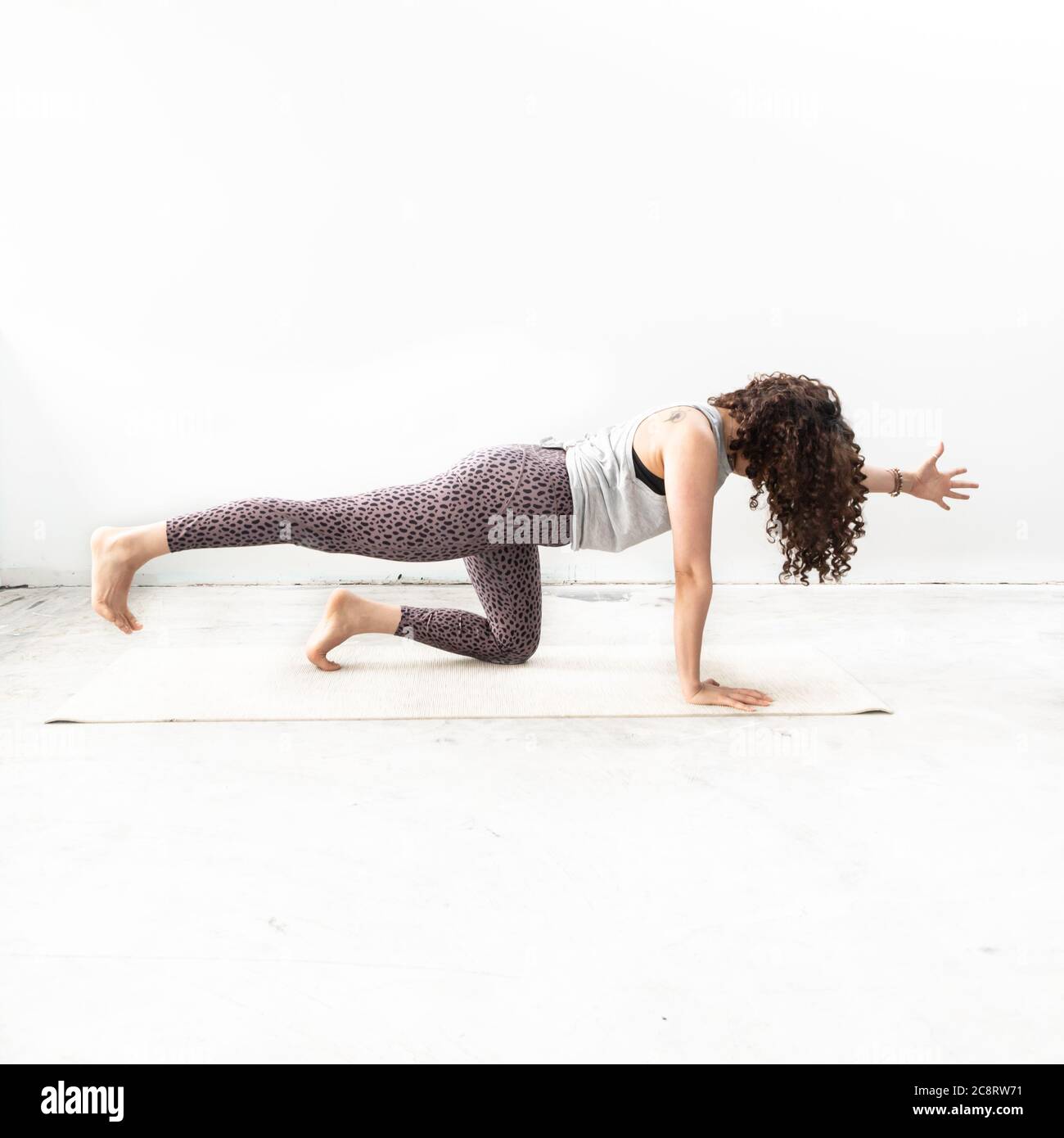Fitness coach demonstrating stretches in studio Stock Photo - Alamy