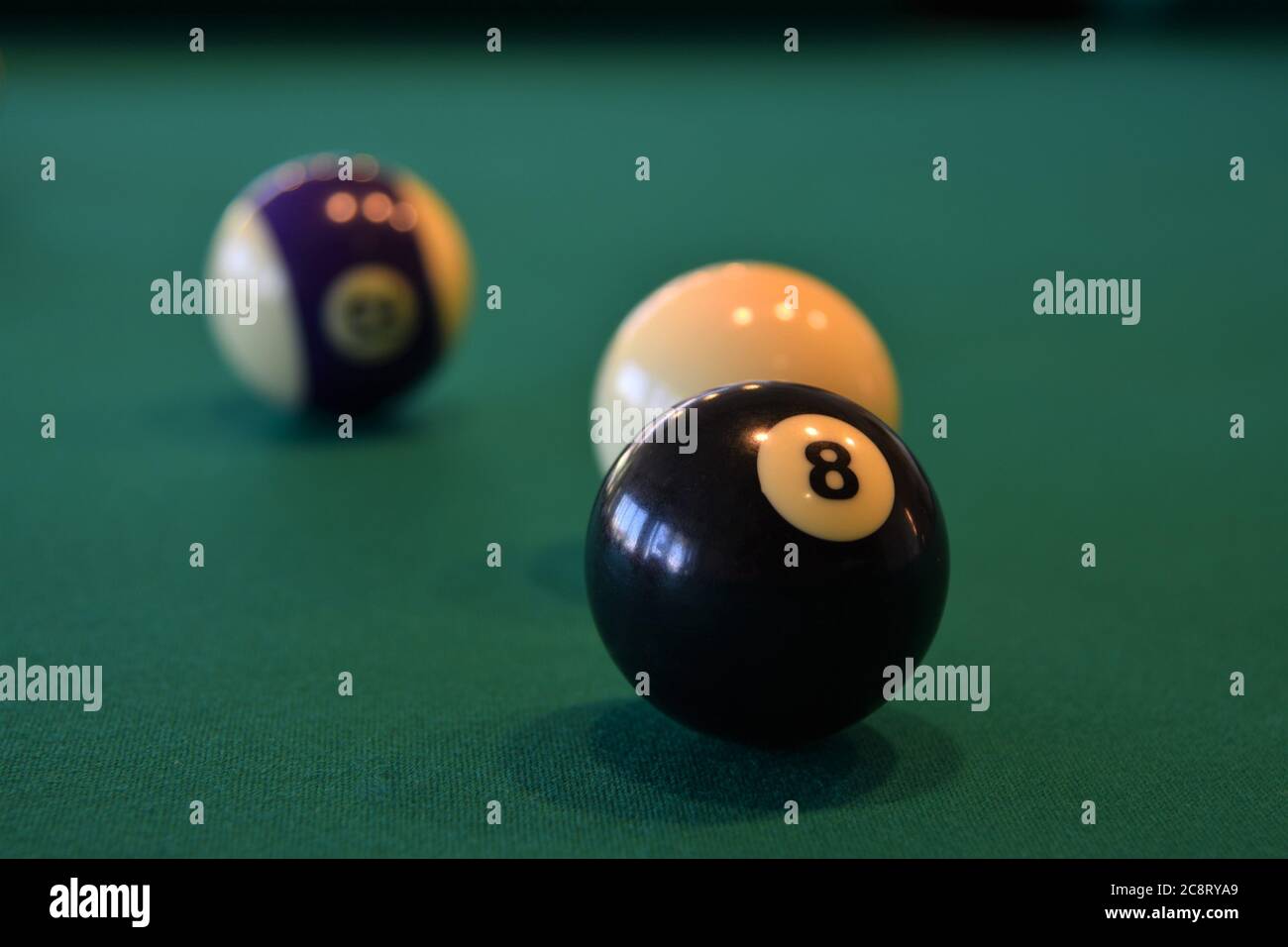 Numbered ball on a green felt pool table Stock Photo - Alamy