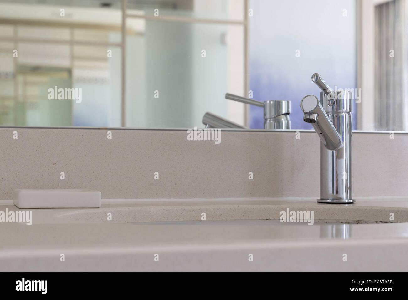 Modern stainless water tap in white bathroom sink, luxury hotel Stock ...