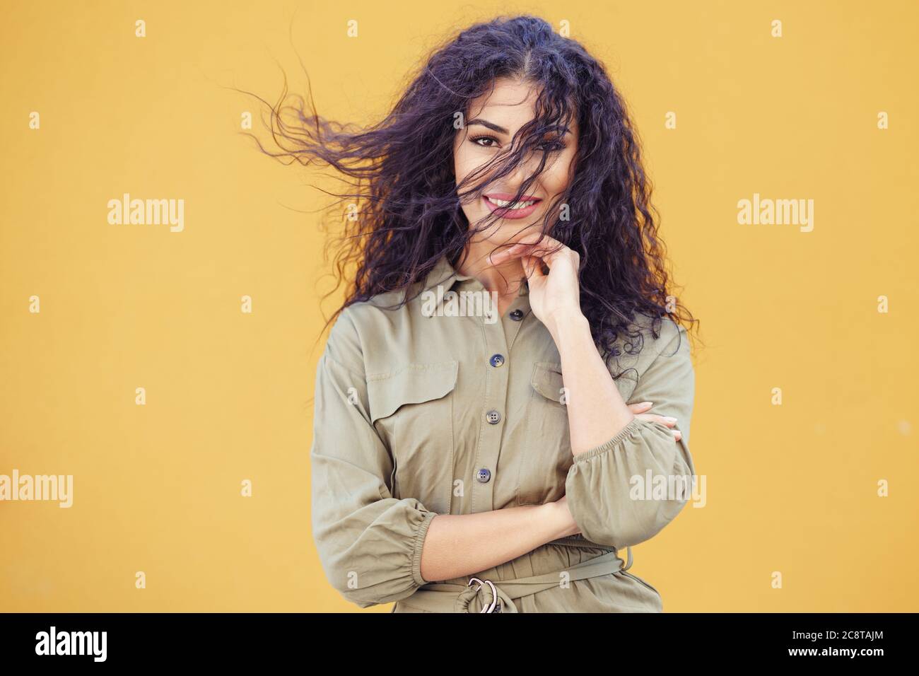 Arab Woman with curly hair in her face Stock Photo - Alamy