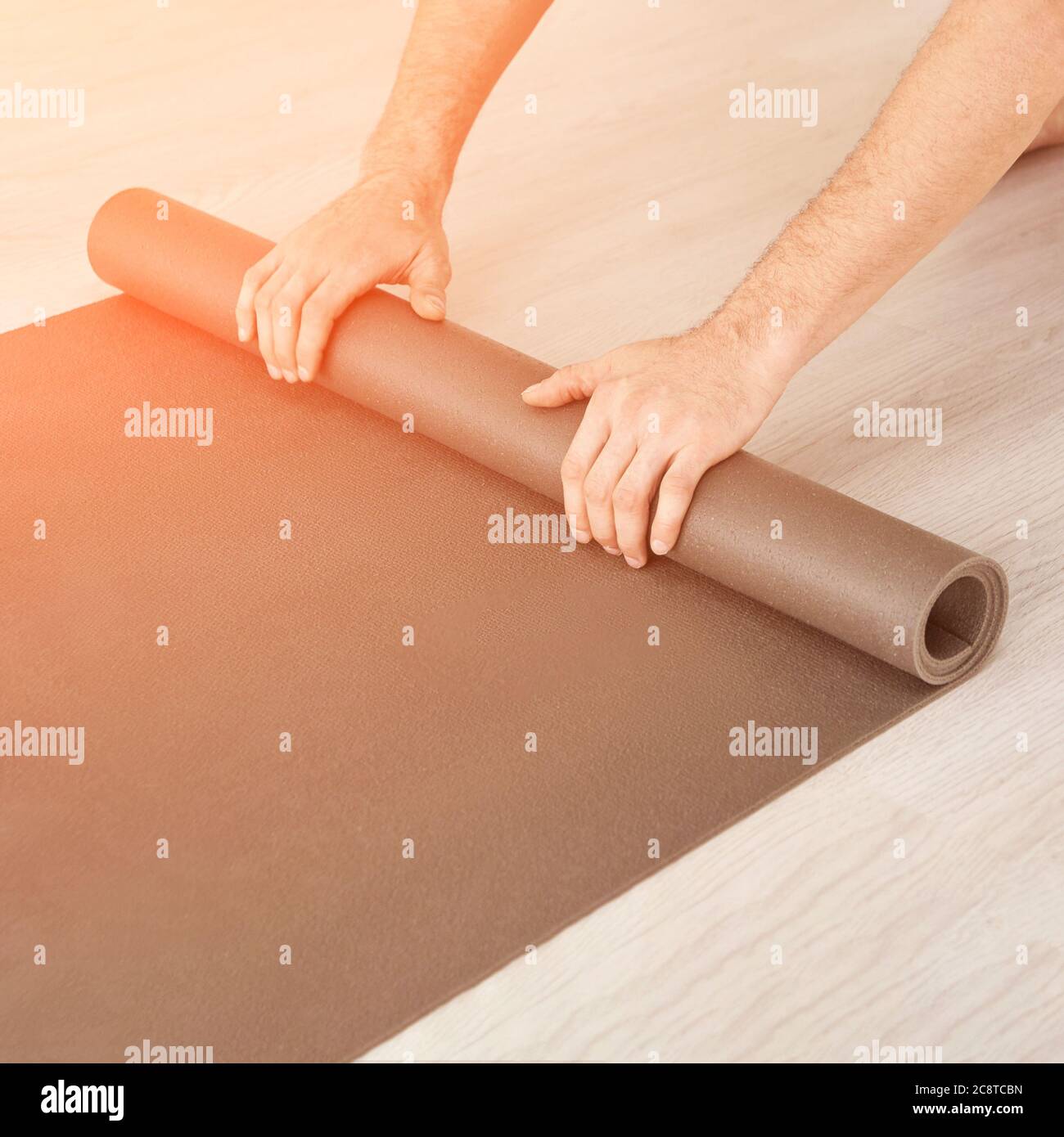 Yoga person rolling sport mat. Grey color. Gym carpet Stock Photo - Alamy