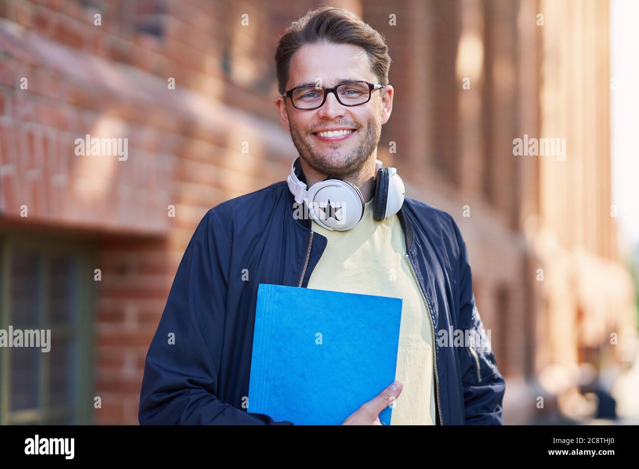 Male student in the campus studying outdoors Stock Photo - Alamy